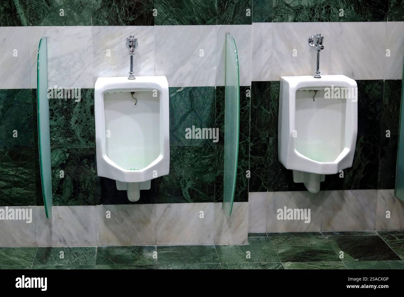 White urinals in men public toilet. Ceramic urinals in a row in men ...
