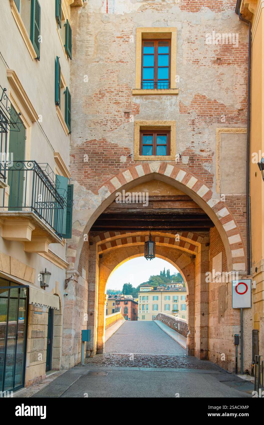 Entrance to Ponte Pietra historic Roman arch bridge in Verona across ...