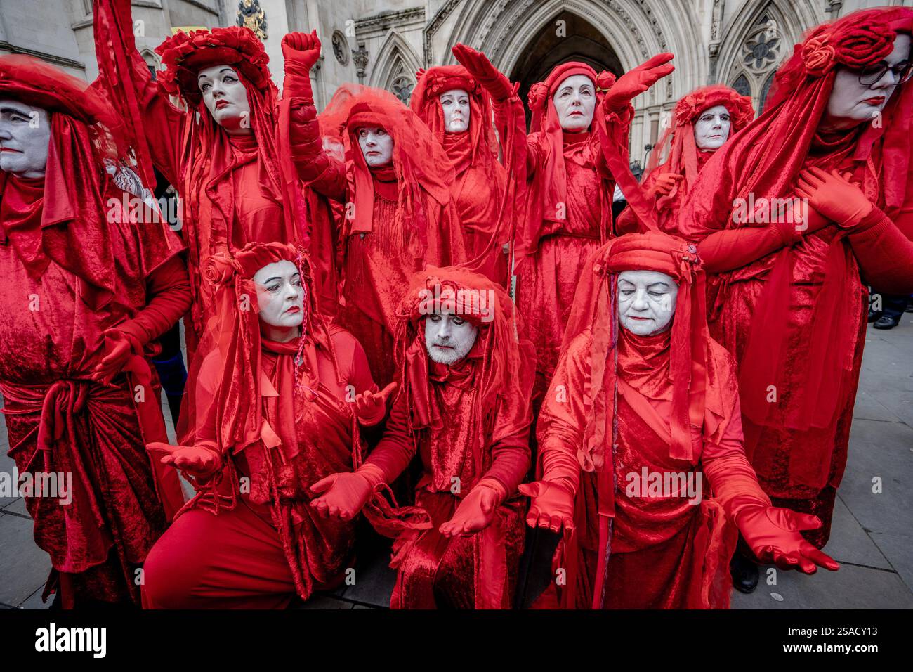 Red rebels perform outside the Crown Court in London during the Mass ...