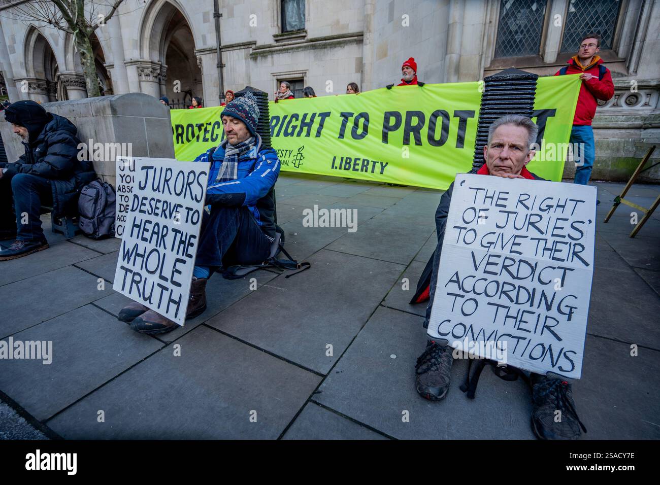 London, UK. 29th Jan, 2025. Protesters hold a banner and placards ...