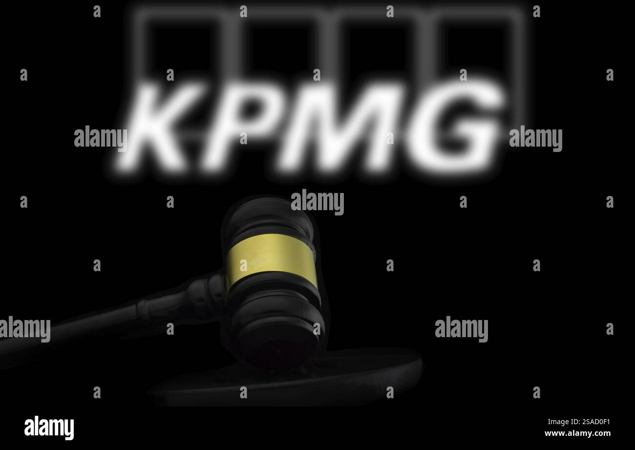 Court gavel in front of the kpmg logo. KPMG International Limited is a ...