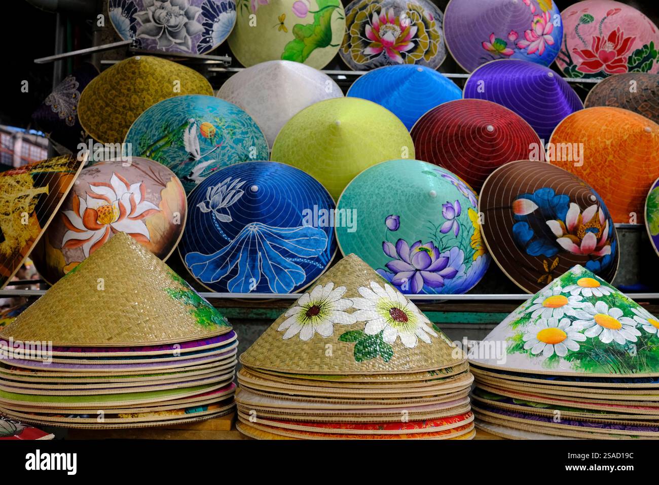 Paddy hats or conical straw hats for sale at a market stall in Dong Ba ...