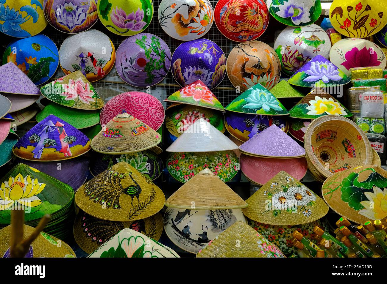 Paddy hats or conical straw hats for sale at a market stall in Dong Ba ...