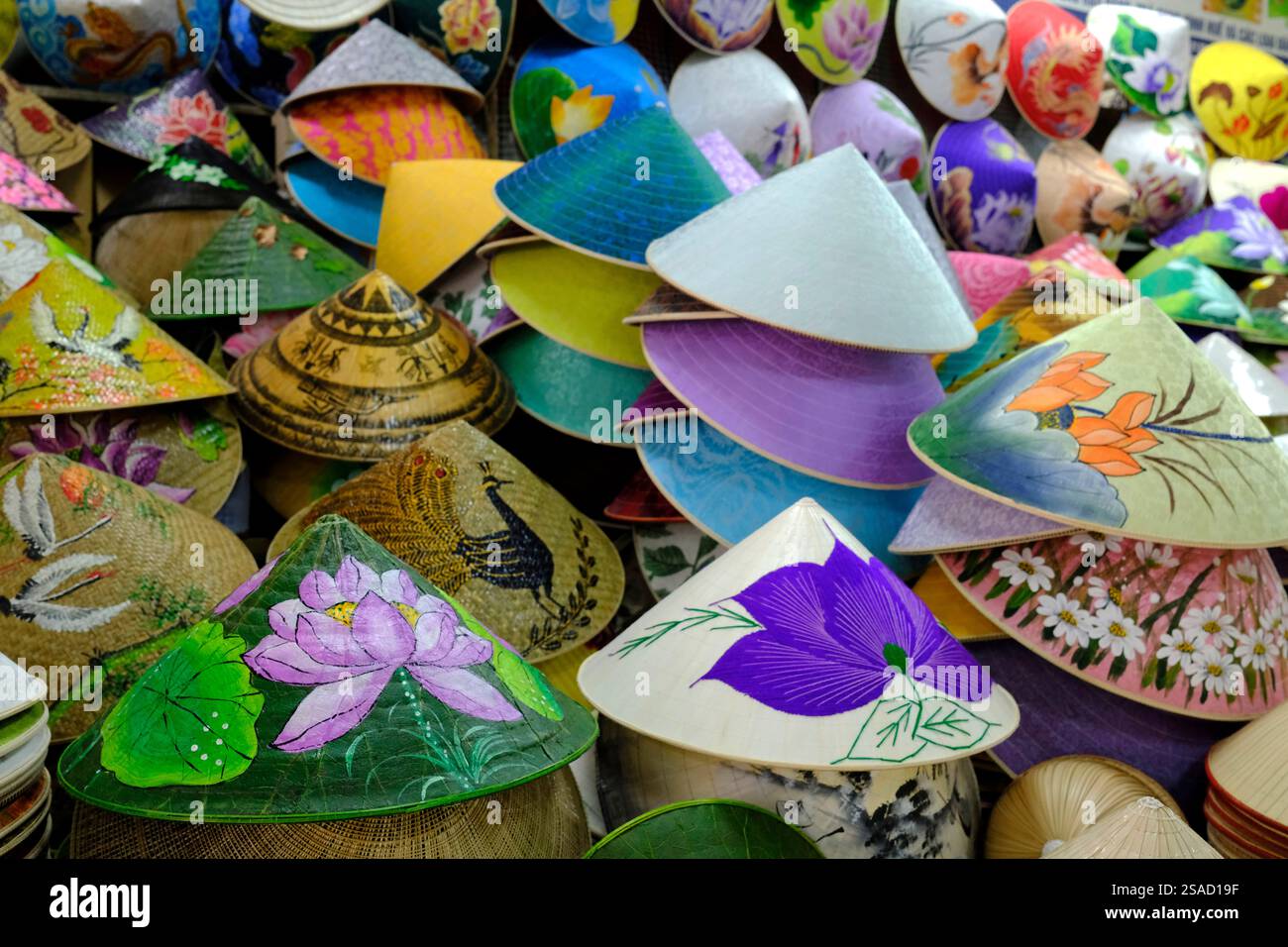 Paddy hats or conical straw hats for sale at a market stall in Dong Ba ...