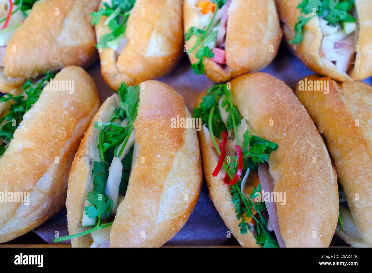 Banh Mi sandwich. Close-up of traditional Vietnamese baguette filled ...