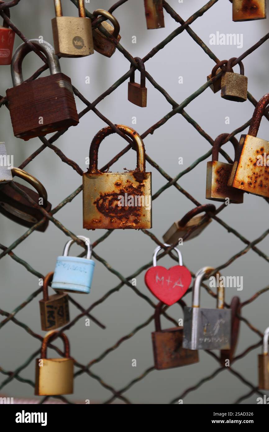 Love locks on bridge with different symbols and characters inscribed on ...