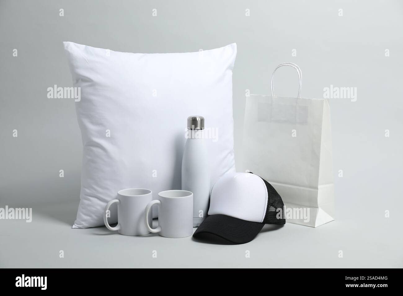 Different blank items for branding on light grey background. Mockup for ...