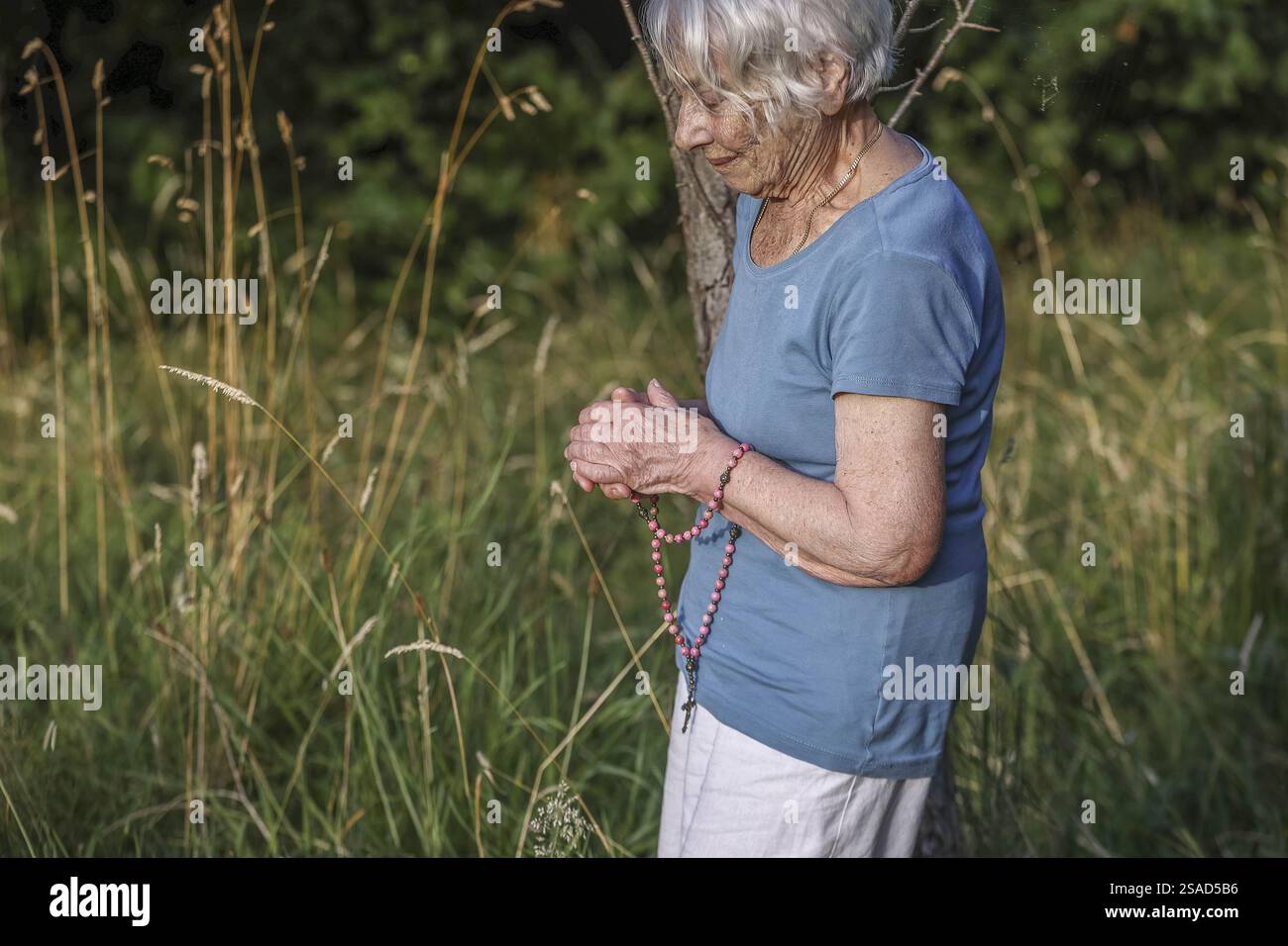 Senior woman praying rosary hi-res stock photography and images - Alamy