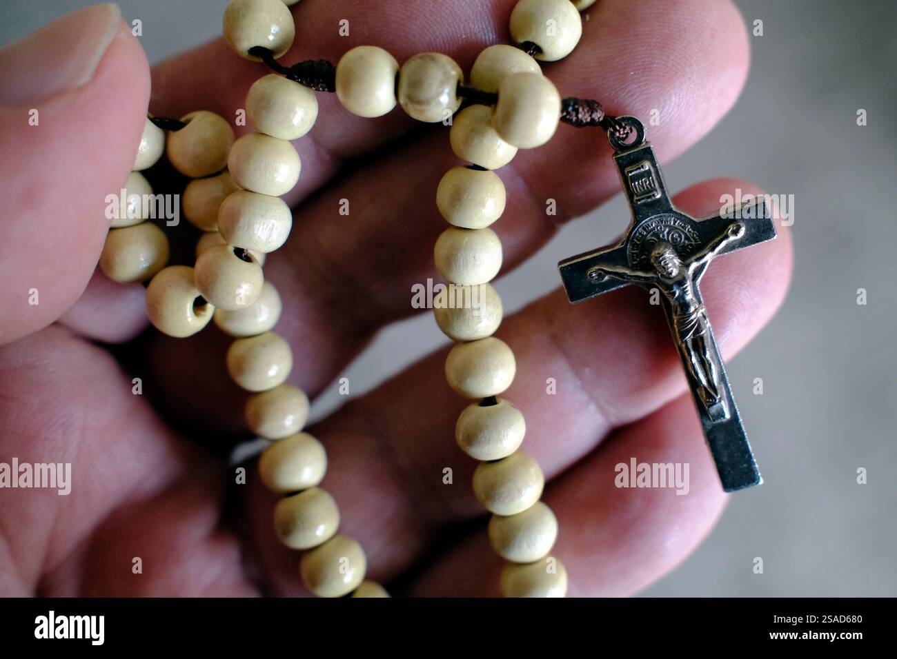 Man praying the rosary. Close-up on crucifix. Germany Stock Photo - Alamy