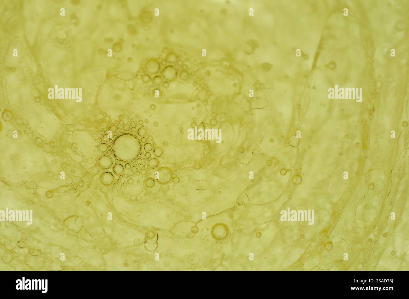 Close-up view of a liquid, likely a mixture of oil and water, or a ...