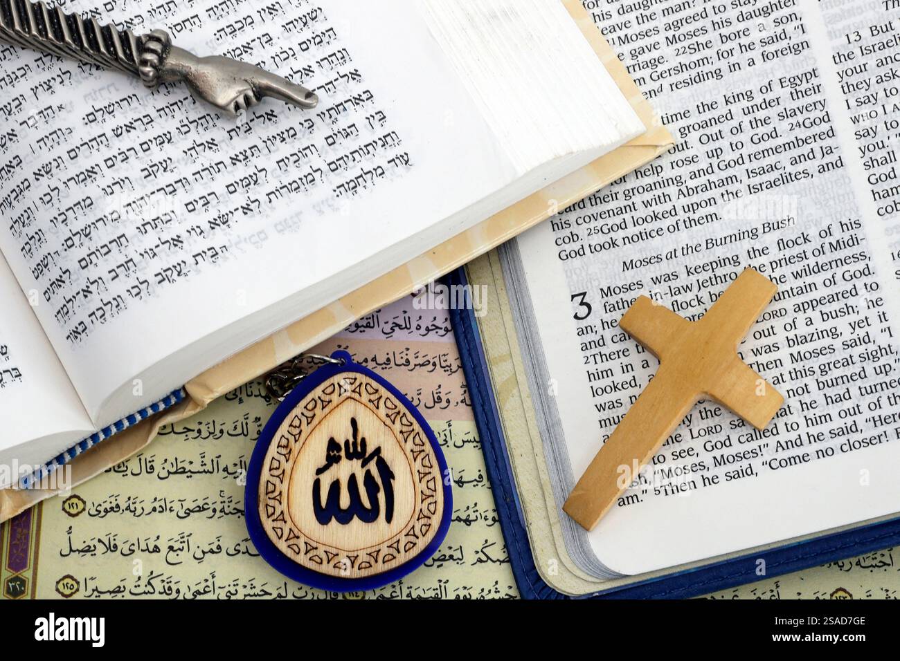 Bible, Quran and Torah with symbols of religions, yad, christian cross ...