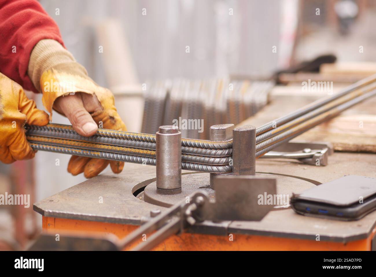 Construction worker bending metal rods at site Stock Photo - Alamy