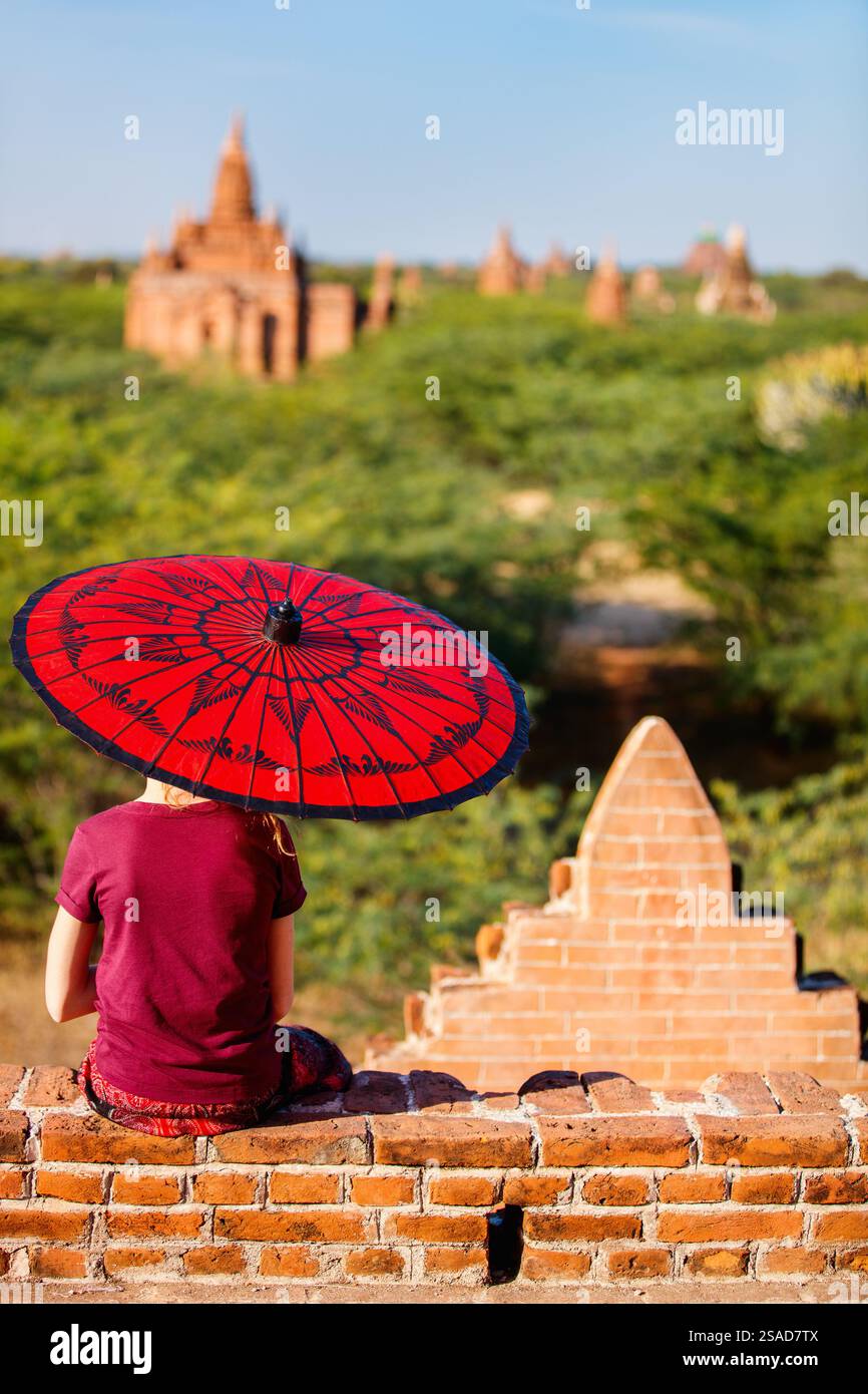 Back view of young girl with traditional burmese parasol enjoying ...