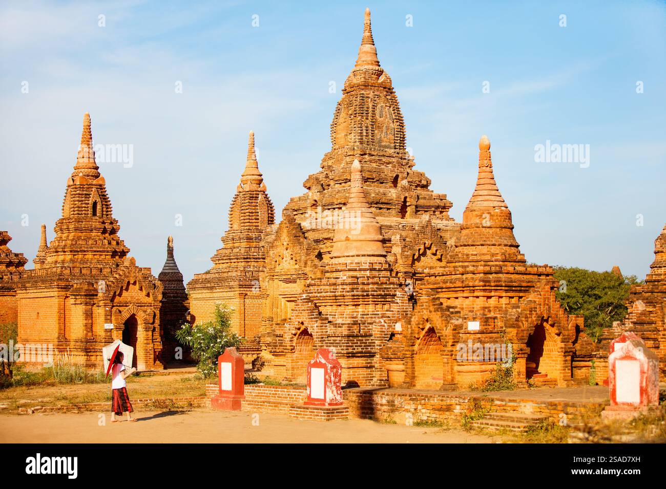Young girl with traditional burmese parasol visiting ancient temples in ...