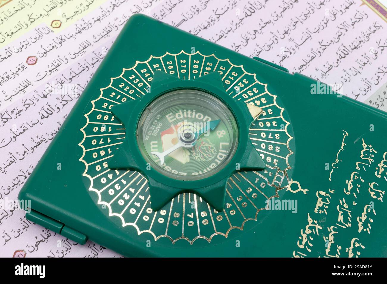 Quran and Islamic compass indicating the direction of Mecca Stock Photo ...