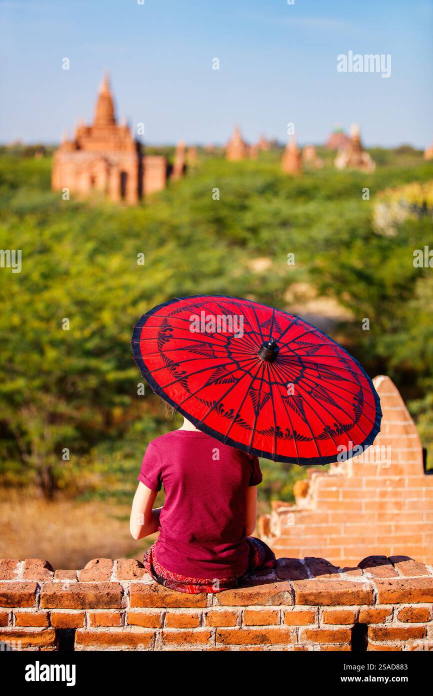 Back view of young girl with traditional burmese parasol enjoying ...