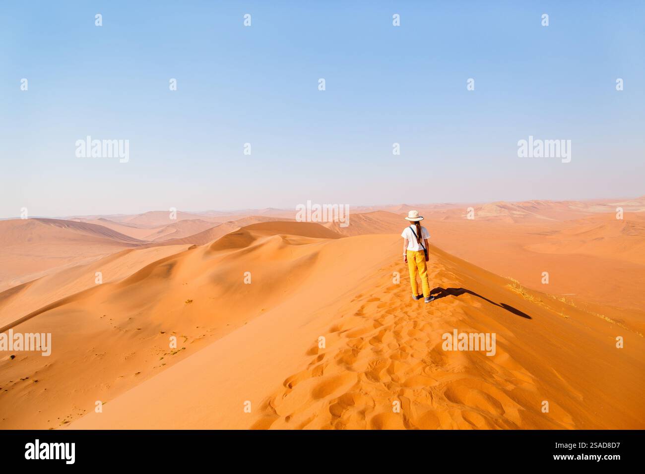 Kids brother and sister climbing up famous red sand dune Big Daddy in ...