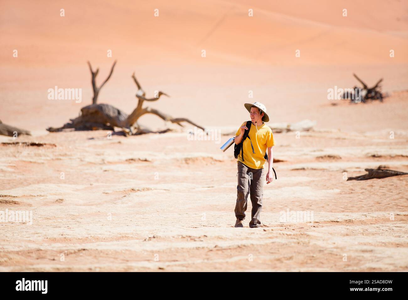 Teenage boy walking in desert in Namibia Stock Photo - Alamy