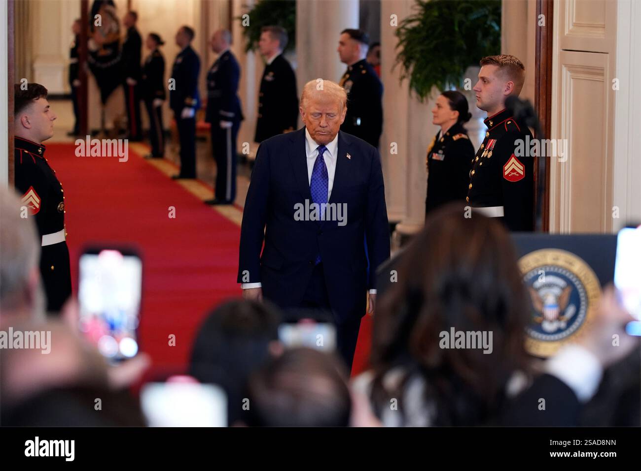 President Donald Trump arrives to sign the Laken Riley Act in the East ...