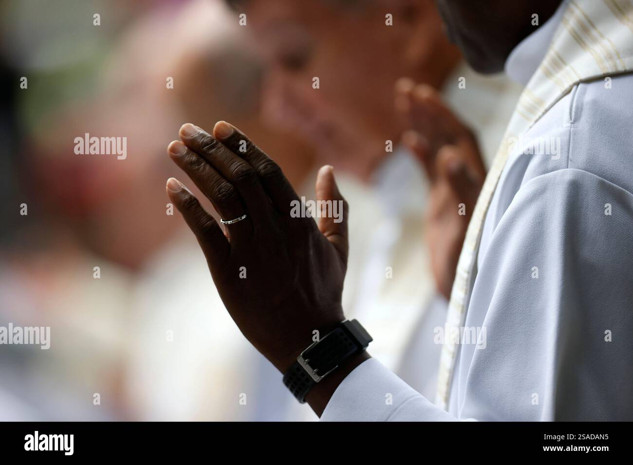 Catholic mass. Lord's Prayer. Priest praying. Close-up on hands. La ...