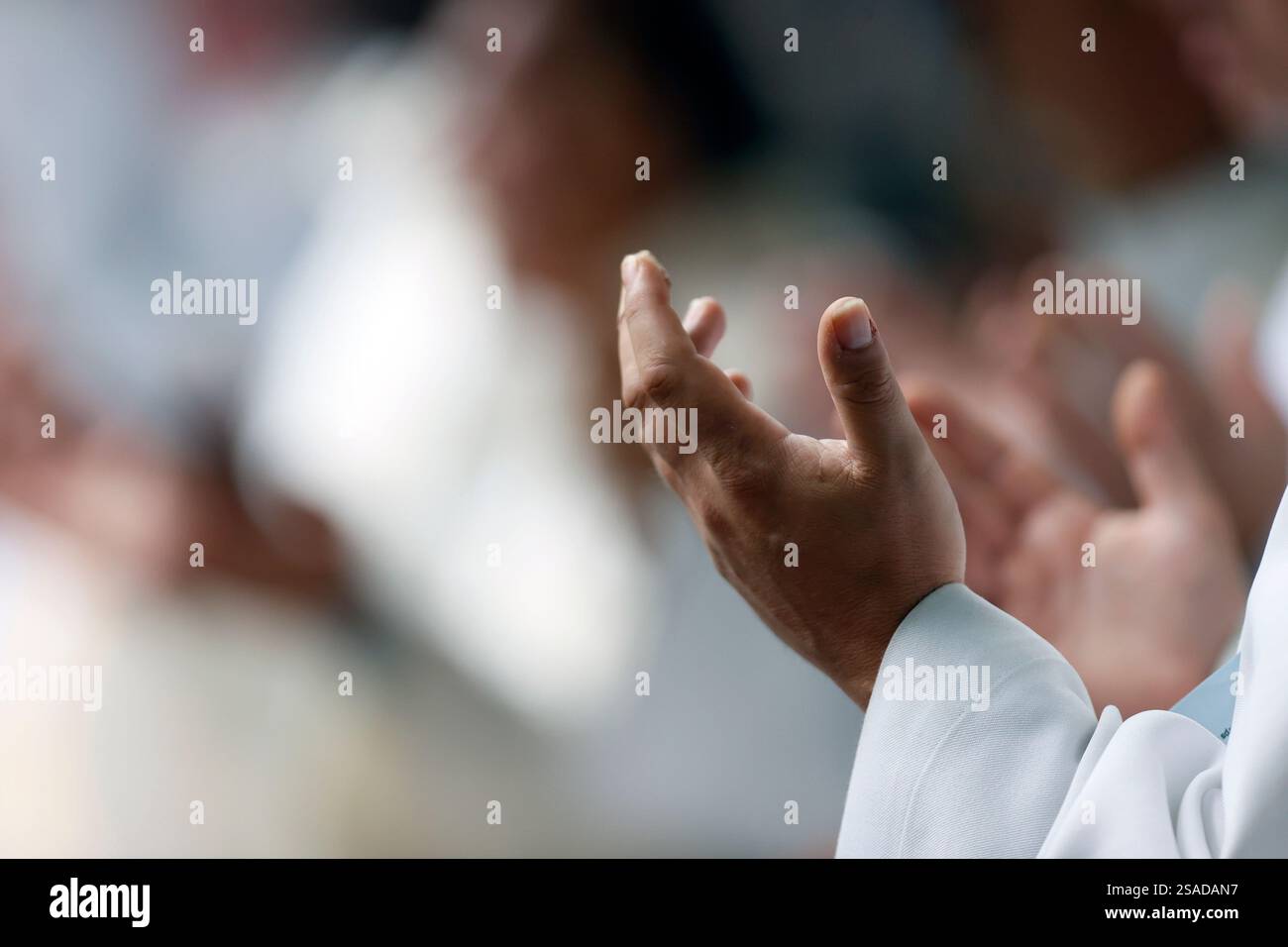 Catholic mass. Lord's Prayer. Priest praying. Close-up on hands. La ...