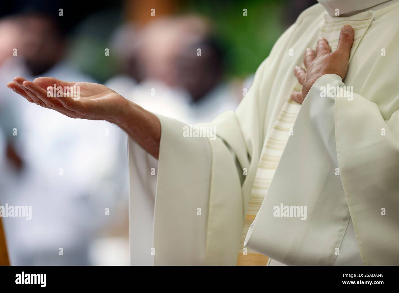Catholic mass. Lord's Prayer. Priest praying. Close-up on hands. La ...