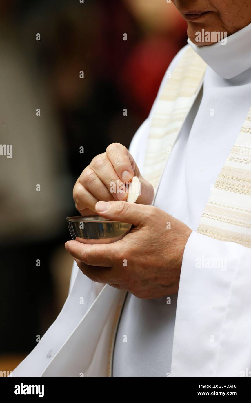 Catholic Mass. Priest giving Communion. Host symbolizing the body of ...