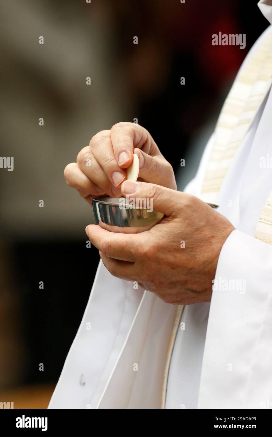 Catholic Mass. Priest giving Communion. Host symbolizing the body of ...