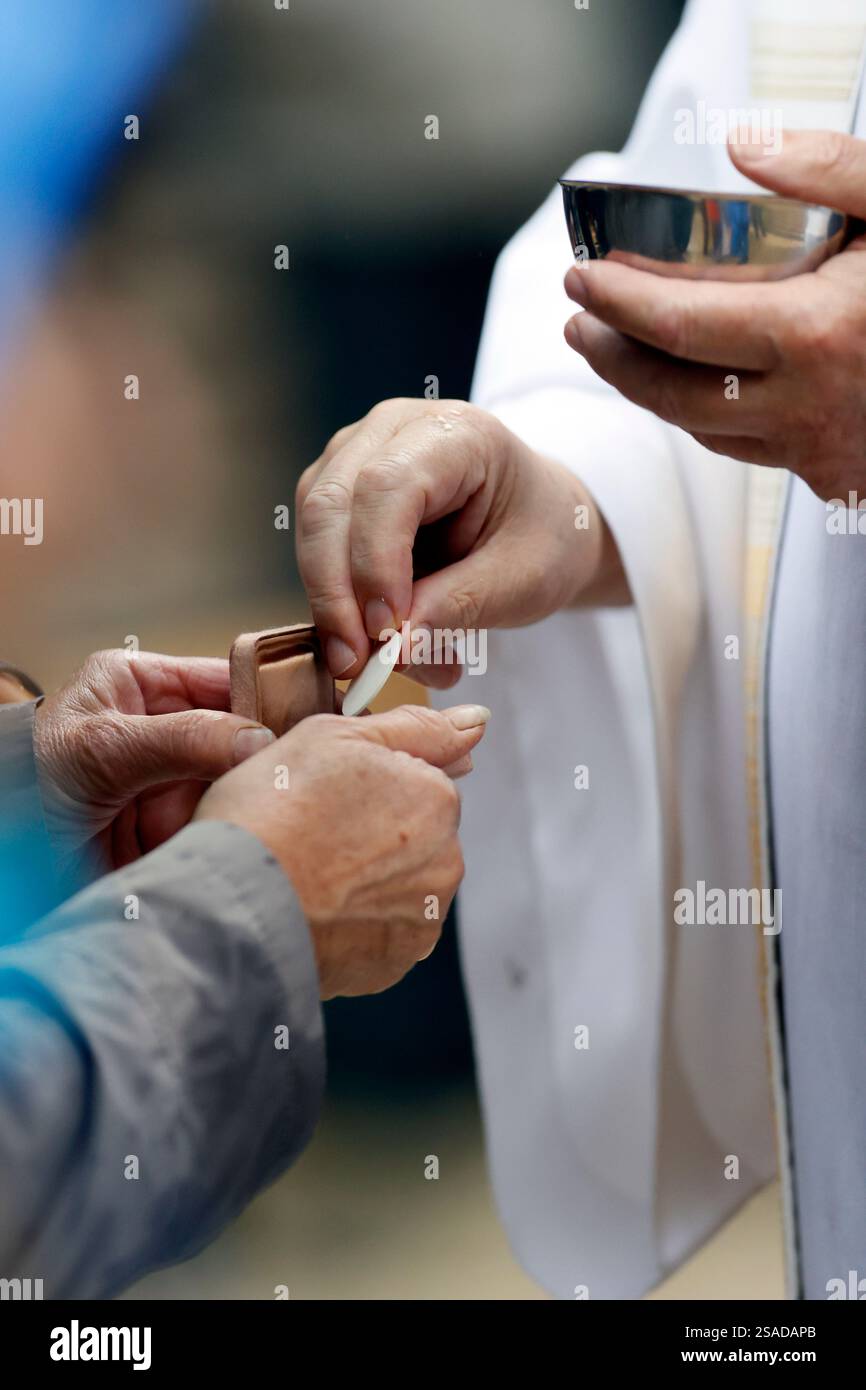 Catholic Mass. Priest giving Communion. Host symbolizing the body of ...