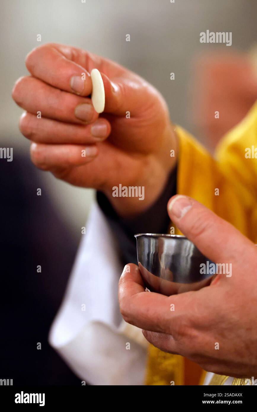 Basilica of the visitation. Catholic mass. Bishop giving Holy Communion ...