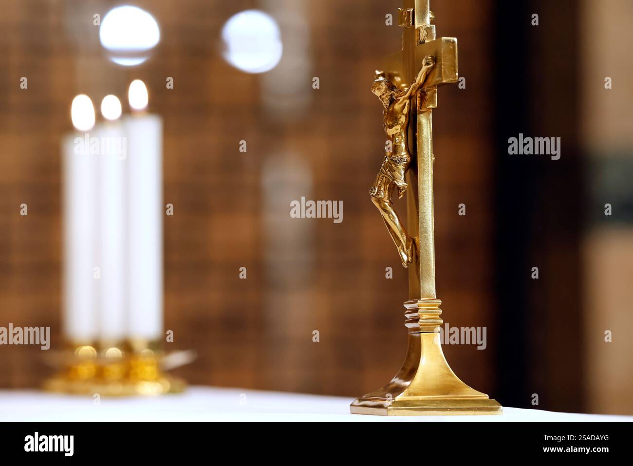 Basilica of the visitation. Crucifix and three lit altar candles ...