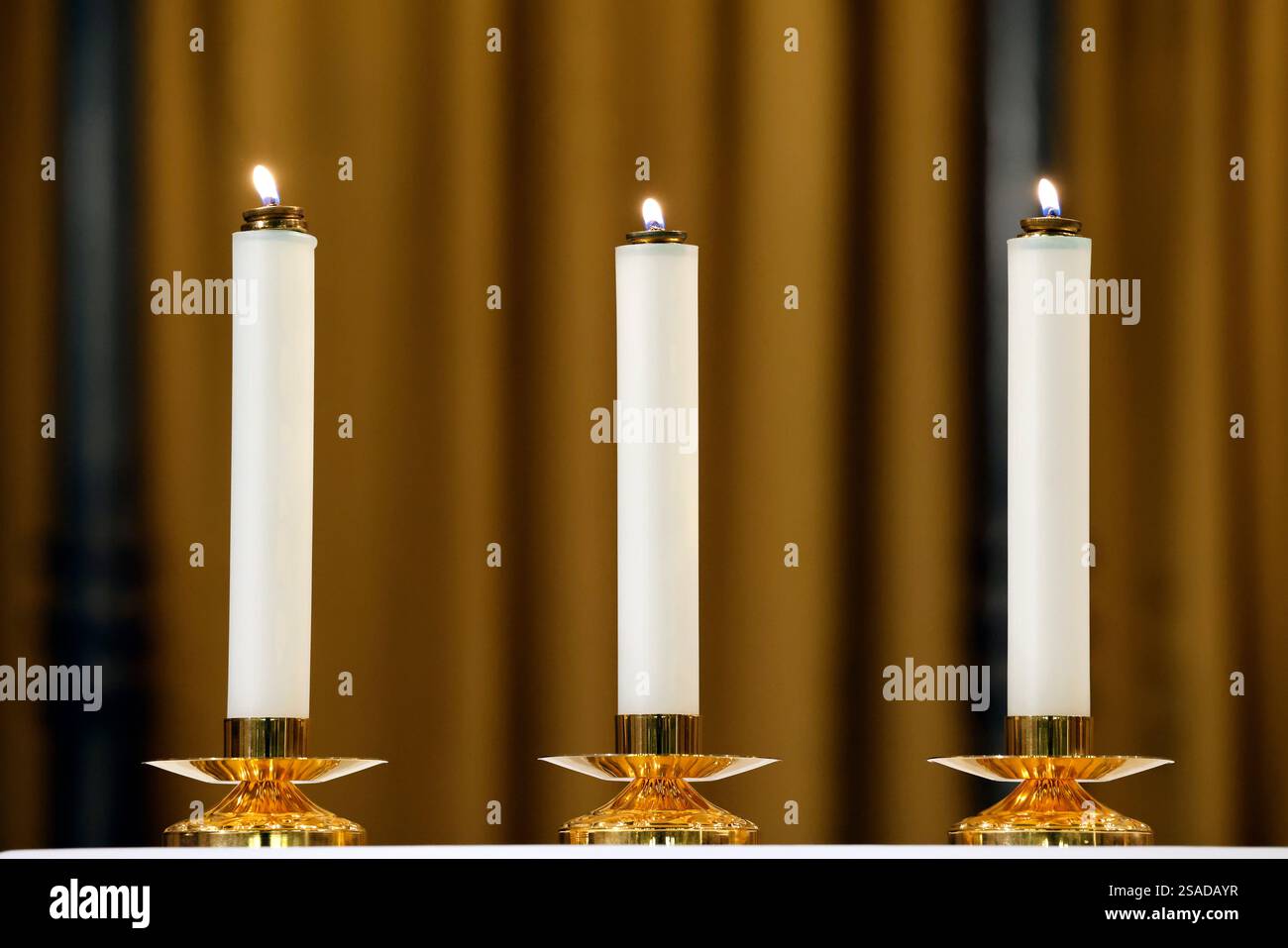 Basilica of the visitation. Three lit altar candles. Catholic church ...