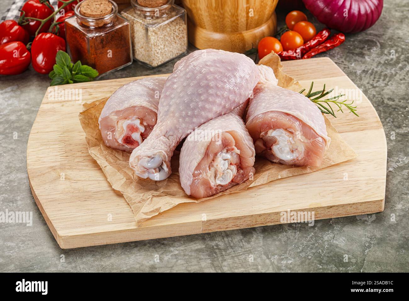 Raw uncooked chicken drumsticks over board for cooking Stock Photo - Alamy