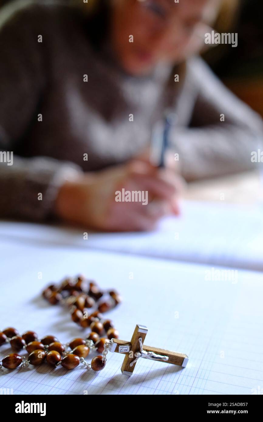 Woman studying the Bible. Wooden rosary. Crucifix Stock Photo - Alamy
