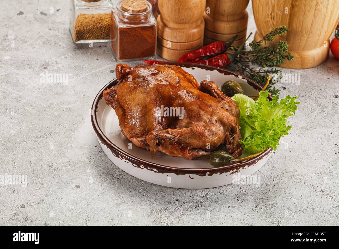 Baked whole small chicken with spices Stock Photo - Alamy