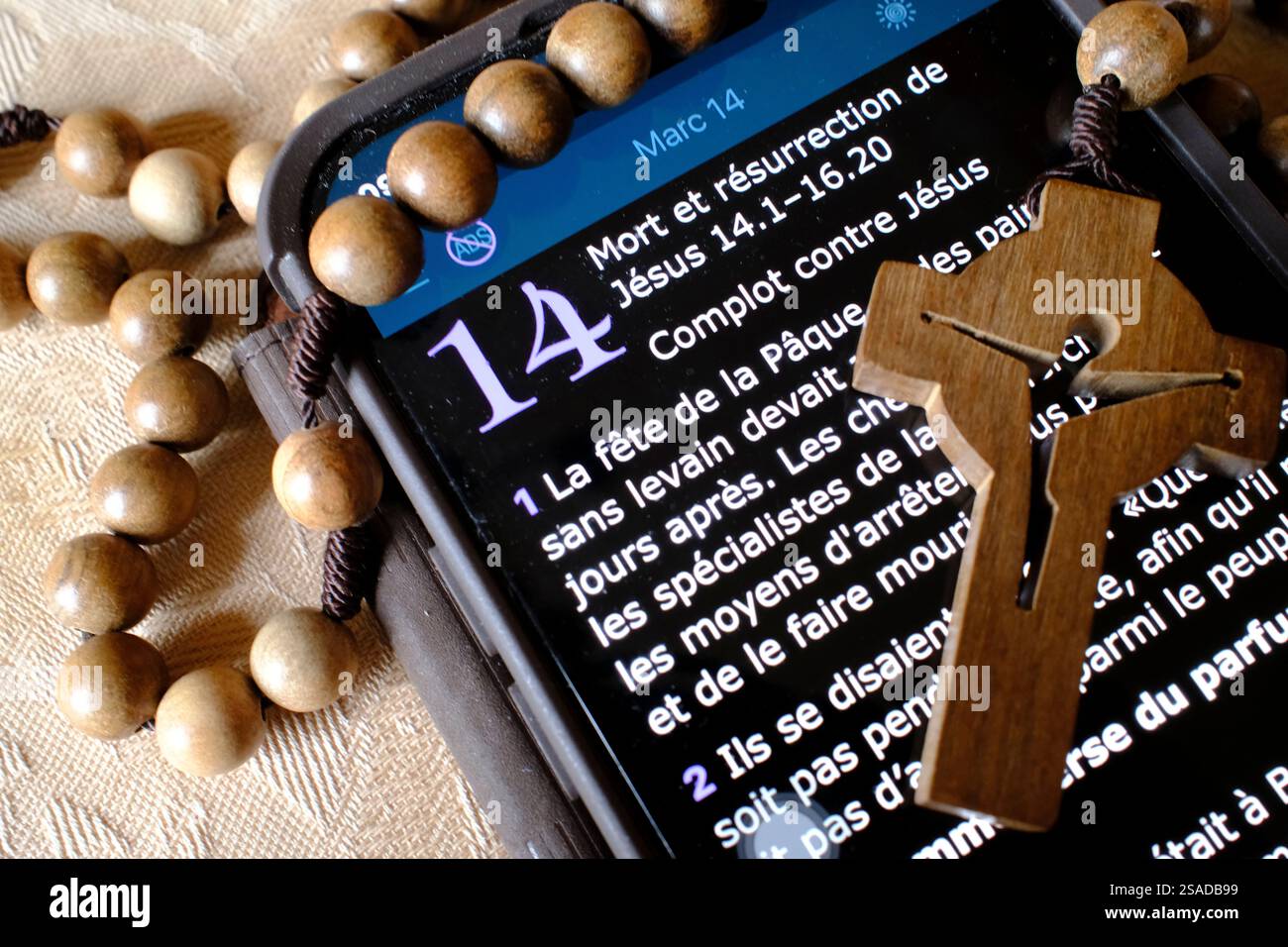 Rosary and digital bible on a smartphone. New testament. Resurrection ...