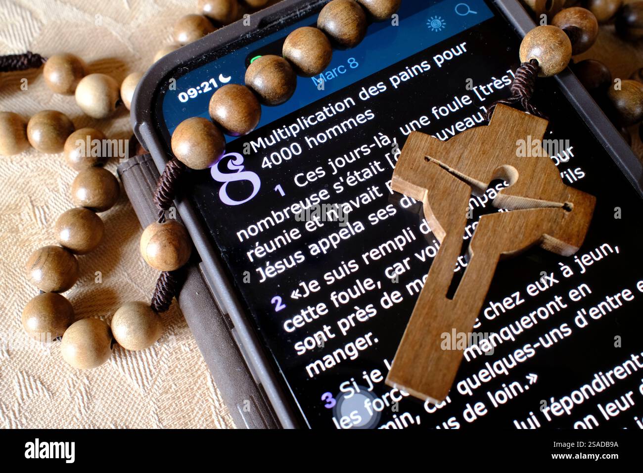 Rosary and digital bible on a smartphone. New testament ...