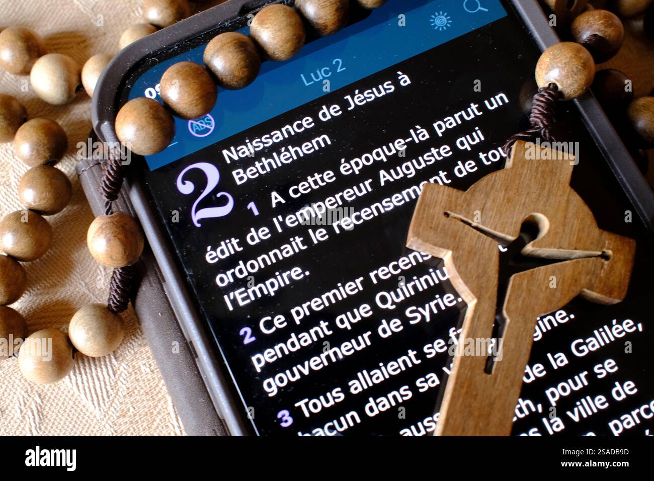 Rosary and digital bible on a smartphone. New testament. Birth of Jesus ...