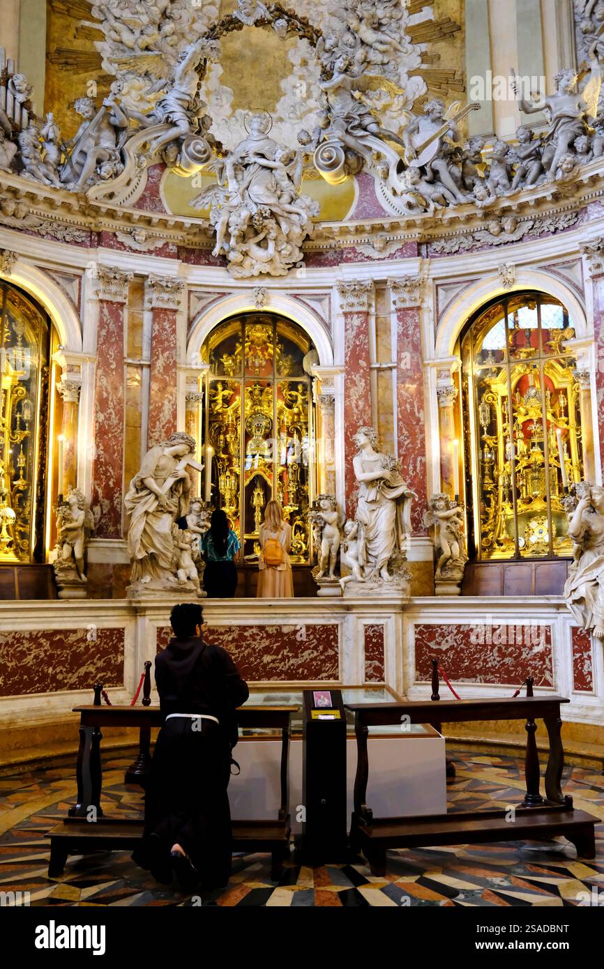 Basilica of Saint Anthony of Padua. The chapel of the relics of Saint Anthony. Monk praying ...