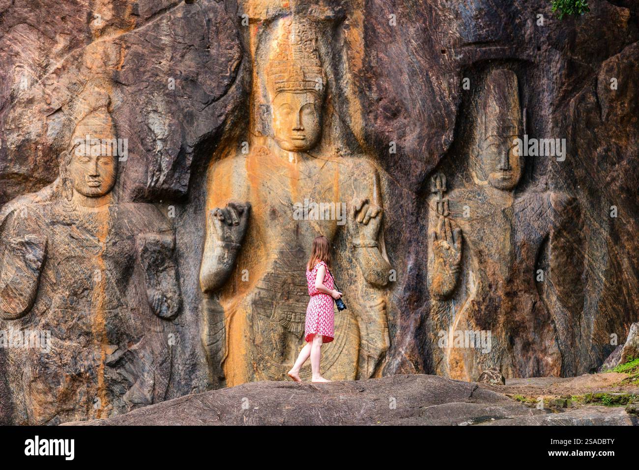 Female tourist visiting Buduruwagala temple with well preserved ...