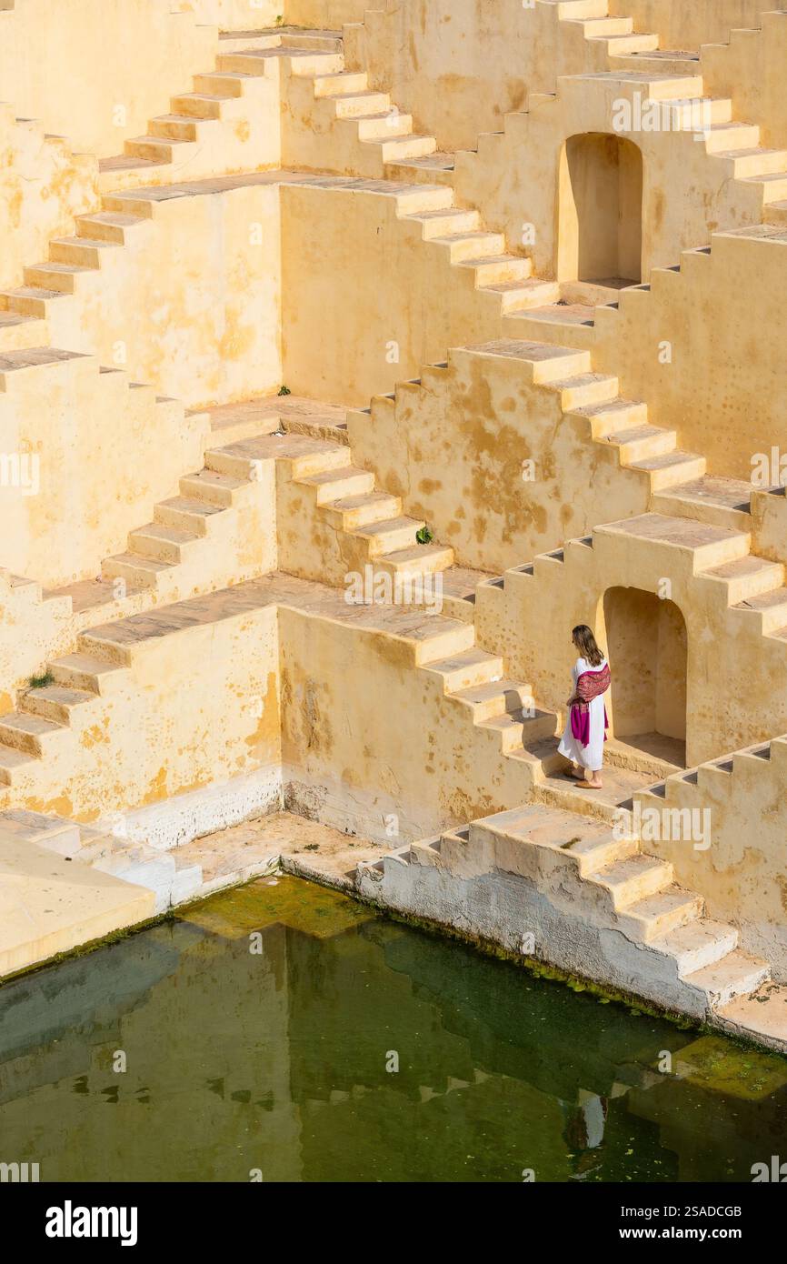 Woman walking down stairs at ancient stepwell in Jaipur India Stock ...