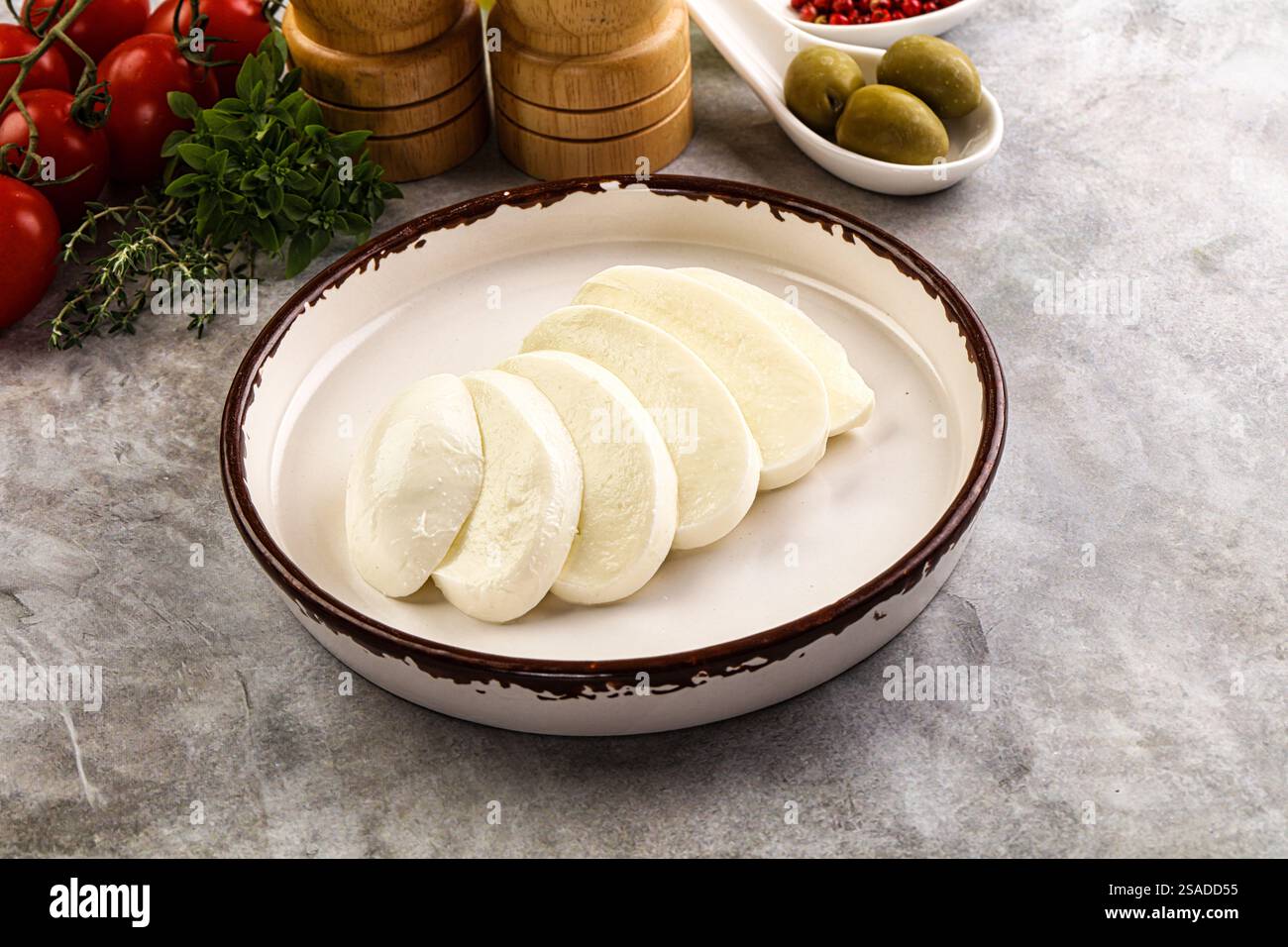 Organic mozzarella cheese slices in the plate appetizer Stock Photo - Alamy