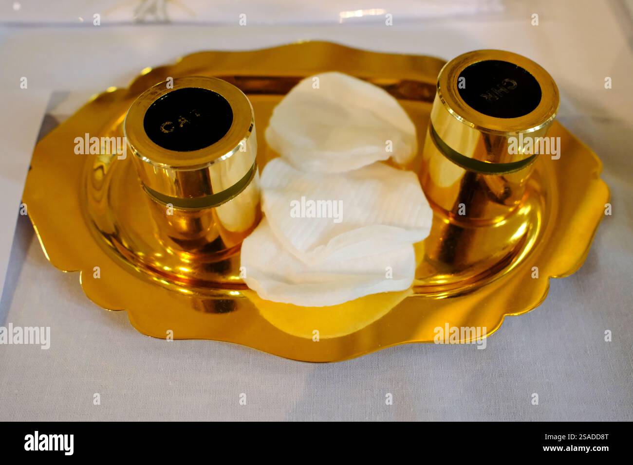 Parish of Saint George. Catholic baptism ceremony. Baptism liturgical objects ready on table ...