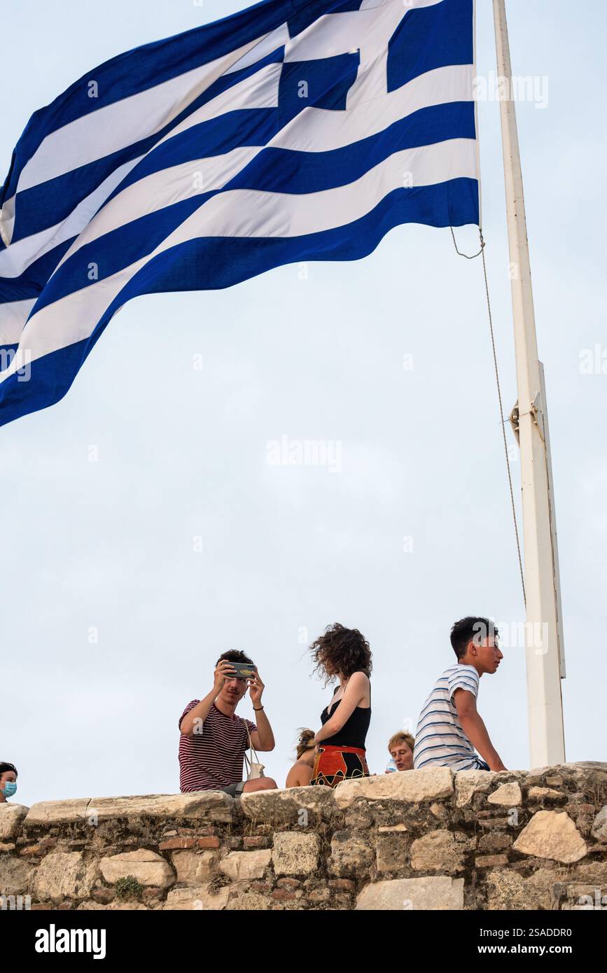 Flag of modern Greece and tourists taking pictures on the east side of ...