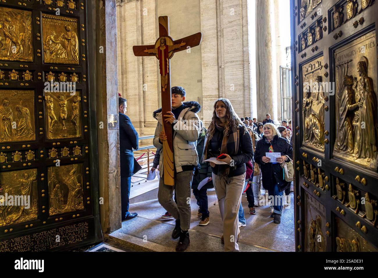 Pilgrims entering St. Peter's basilica through the Holy Door during the ...