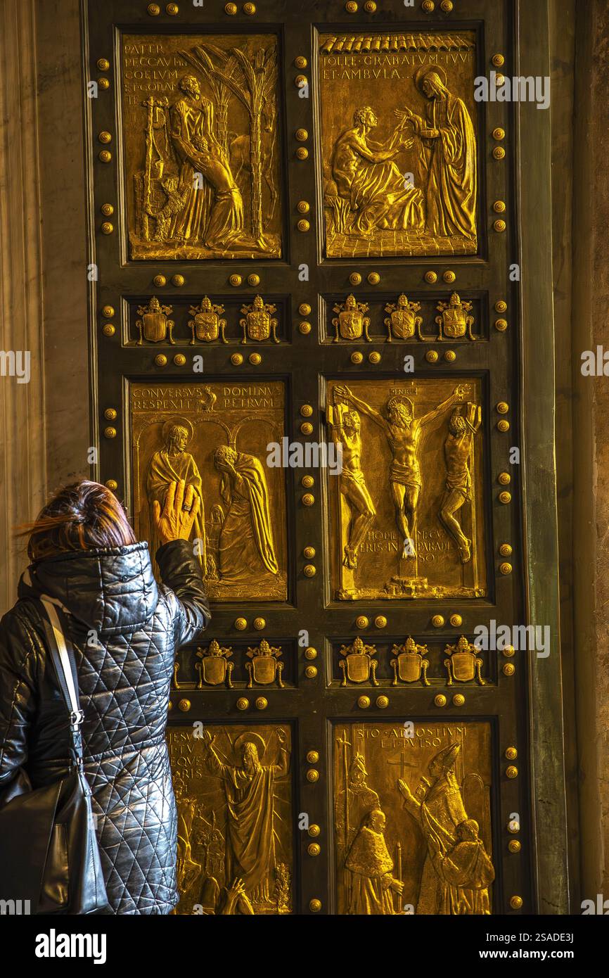 Pilgrim entering St. Peter's basilica through the Holy Door during the ...