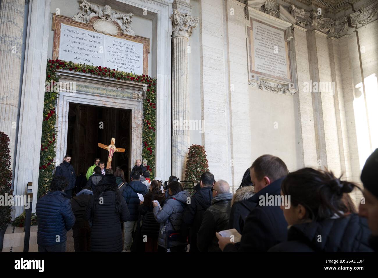 Pilgrims pass through the Holy Door of St. Peter's Basilica during the ...
