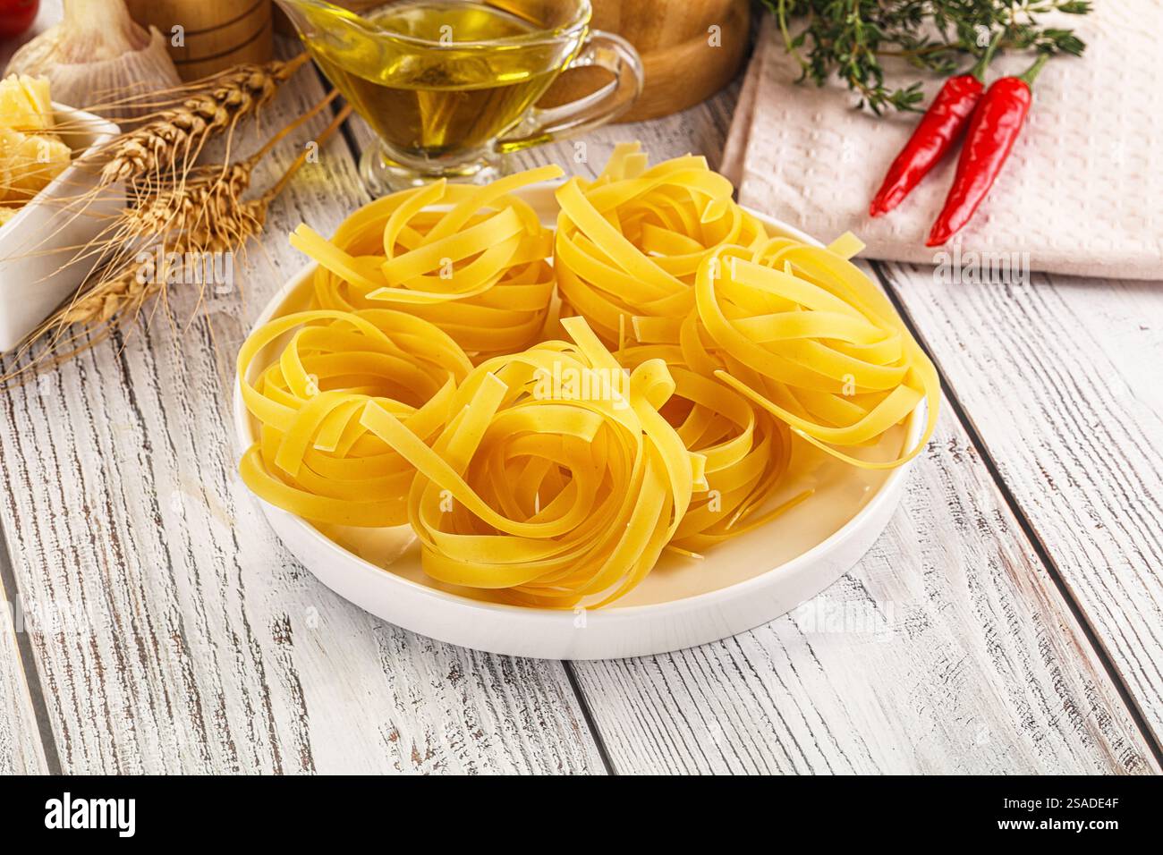 Raw dry Italian pasta - pappardelle for bowl Stock Photo - Alamy
