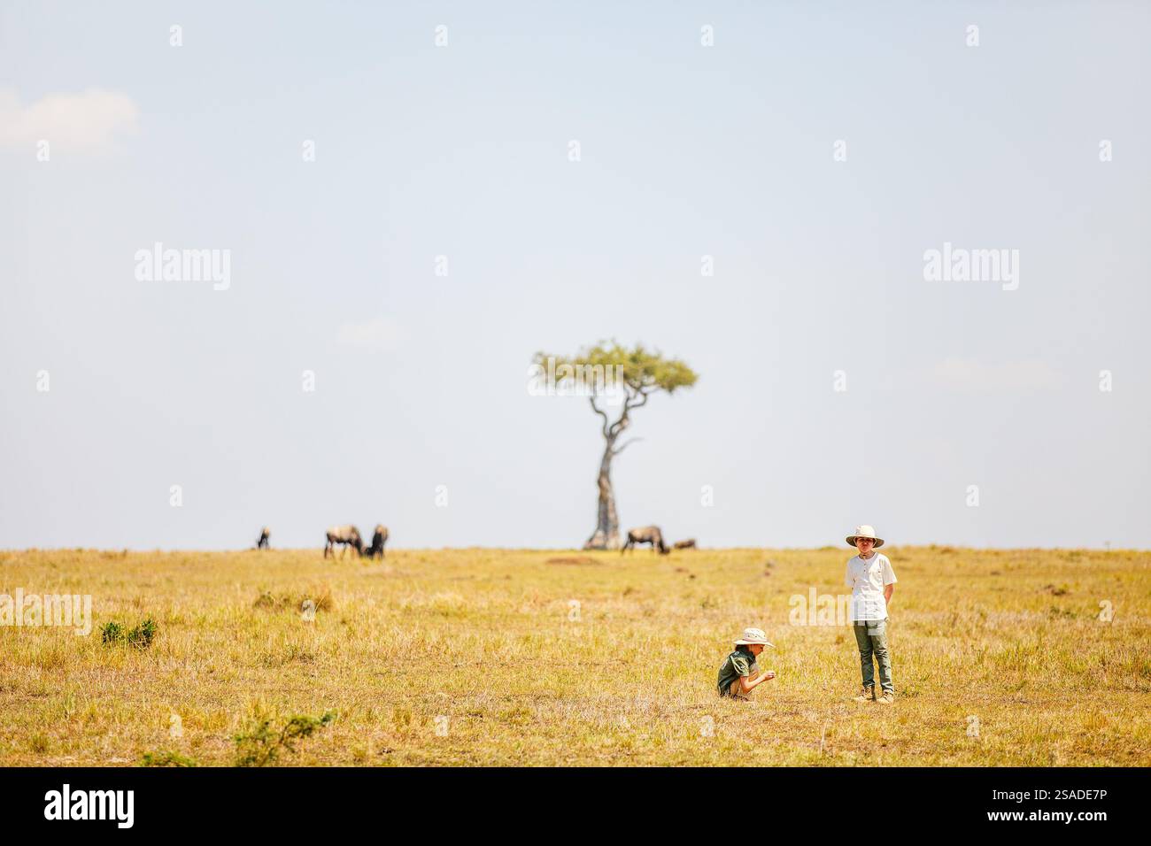 Kids witnessing great migration of wildebeests in Masai Mara National ...