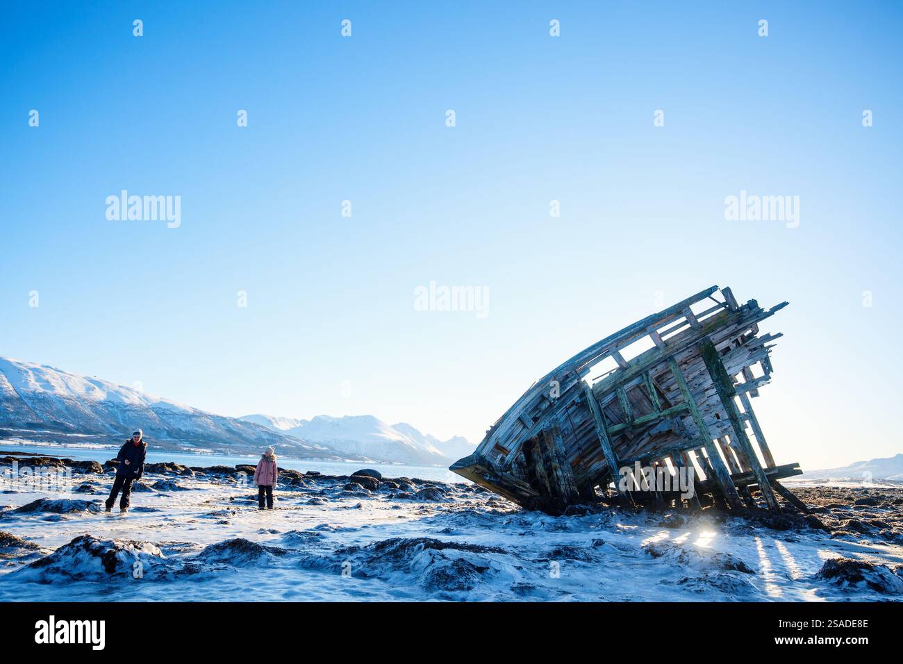 Kids exploring shipwrecked wooden viking boat in Northern Norway Stock ...